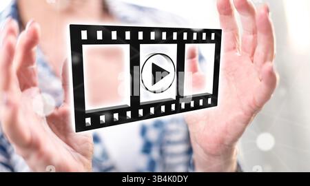 Movies, video and cinema concept between hands of a man in background ...