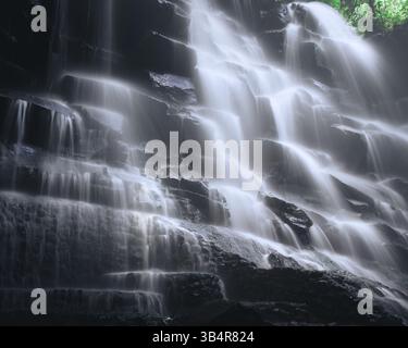 A powerful flow of water cascades over a man-made weir near Cascata do ...