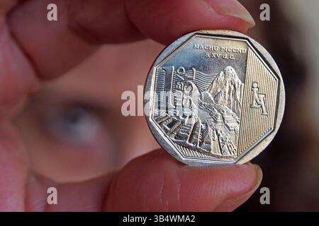 Peruvian coin; 2011 Un Nuevo Sol coin, with Machu Picchu theme, hold ...