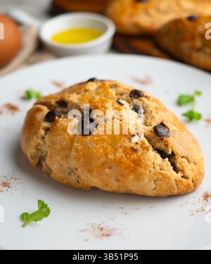 Triangular English scones with dark chocolate chips. Top view table ...