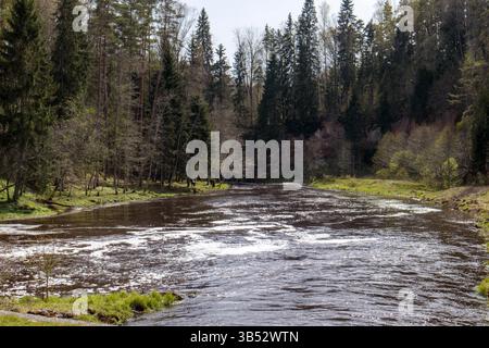 Calm water slowly flowing,on a mild afternoon in England,as sunset ...