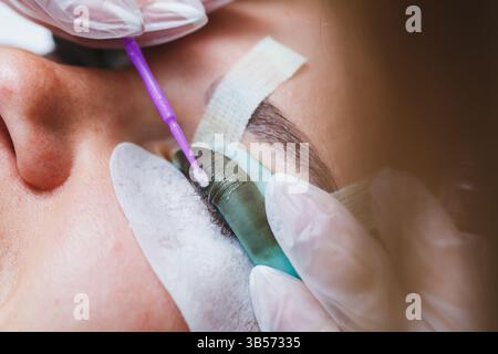 Permanent makeup. Beauty procedures. The master applies a tattoo on the ...