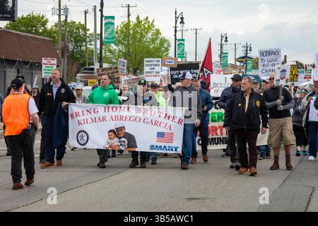 People deported from the United States sit inside a processing center ...