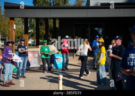 A voter walks past a voting booth before casts her ballot, Tuesday ...