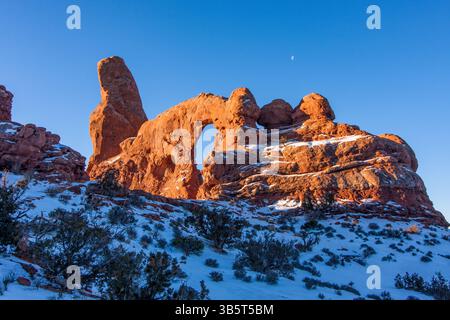 Half moon over Turret Arch with snow in winter in the Windows Section ...