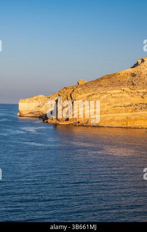 Oman: view at sunset of the stunning beach of Qantab, small traditional ...