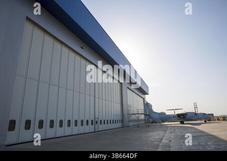 Airport hangar from the outside with big tall doors Stock Photo - Alamy