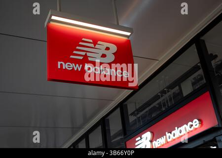 New Balance outlet store storefront and logo Stock Photo - Alamy