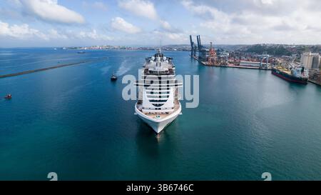 Front view of luxurious cruise ship sailing slowly inside the harbour ...