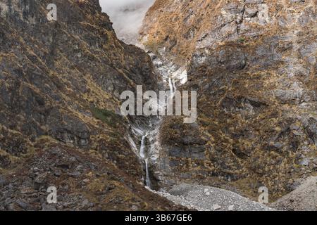 Beautiful Himalayan Glacial Waterfalls in the Mountains with a Bridge ...