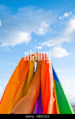 A hand holds LGBTQ pride flag during the Delhi Queer Pride Parade, an ...