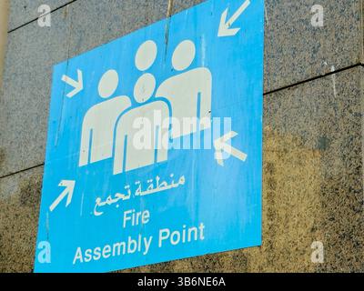 Assembly Point Sign in Arabic and English languages that uses safety ...