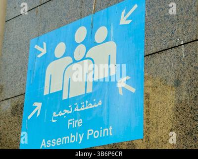Assembly Point Sign in Arabic and English languages that uses safety ...