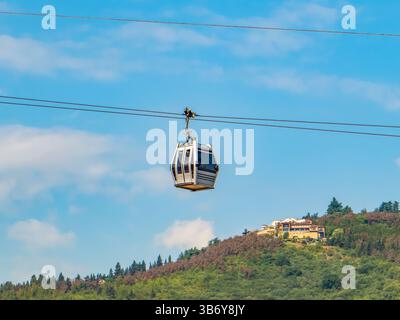 Modern cable cars moving above Tbilisi, Georgia, with a scenic ...