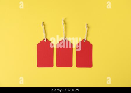 Blank tags with strings on yellow background, flat lay Stock Photo - Alamy
