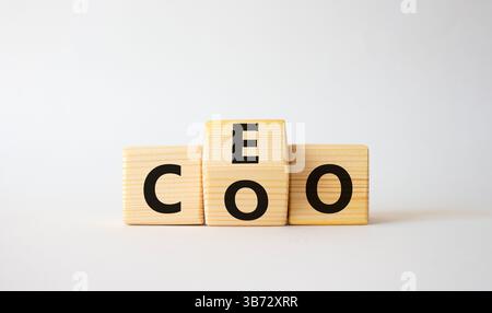 CEO and COO symbol. Turned wooden cubes with words CEO and COO ...