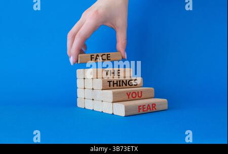 Face the things you fear symbol. Wooden blocks with words Face the ...