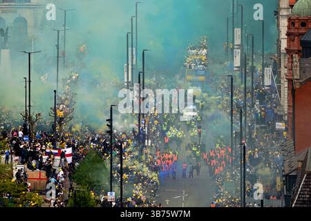 Fans line the street as the Leeds United parade buses enter the city ...