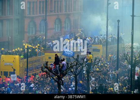 Fans line the street as the Leeds United parade buses pass through the ...