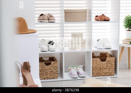 Shoe storage. Shelving unit with different footwear indoors Stock Photo ...