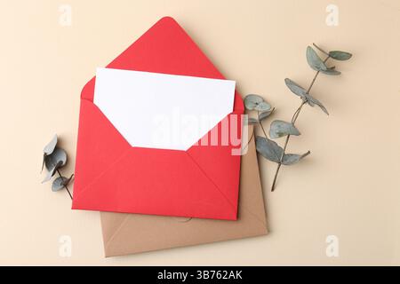 Envelopes with blank card and eucalyptus on grey background Stock Photo ...