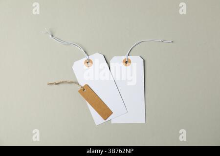 Blank tags with strings on grey background, flat lay Stock Photo - Alamy