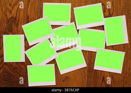 Many blank photographs lie on a wooden table Stock Photo - Alamy