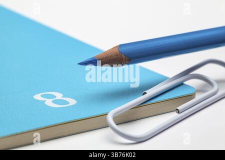 Organizer for the month of August, blue pencil and white paperclip on ...
