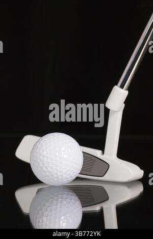 Golf putter and different golf equipments on the black glass desk Stock ...