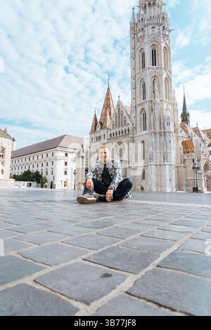 Cool cheerful teenage hipster in overalls and yellow hat standing ...