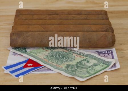 Luxury Cuban cigars and money on the wooden table Stock Photo - Alamy