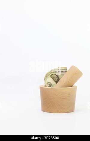 Mortar made of tropical wood and us dollar banknote on white background ...