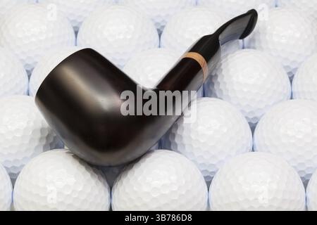 Luxury tobacco pipe on the white golf balls Stock Photo - Alamy