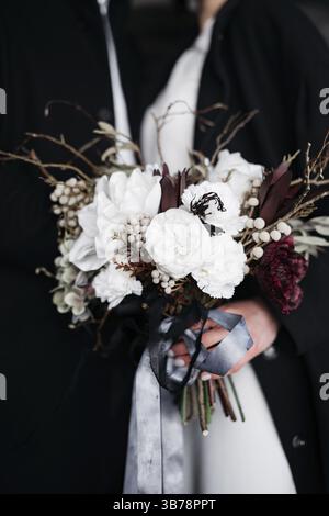 Destination Iceland wedding. Close-up of the groom's legs. Holds a ...