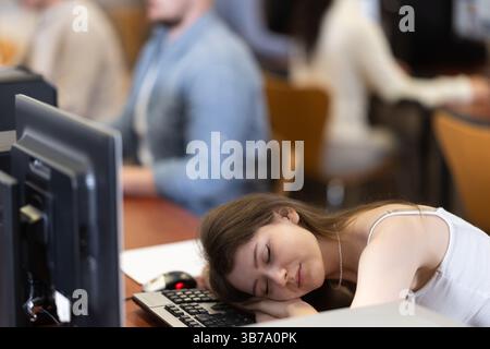 Young woman fell asleep at table in office Stock Photo - Alamy