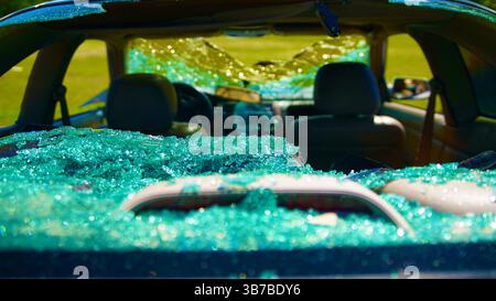 Shattered car windows and scattered glass show the aftermath of a crash ...