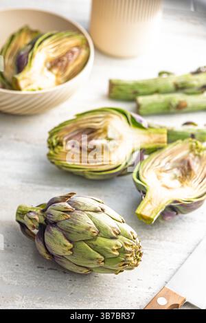 Artichokes on kitchen table Stock Photo - Alamy