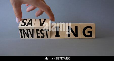 Saving or investing symbol. Businessman turns cubes and changes the ...