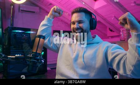 Young caucasian man streamer playing video game using computer at ...