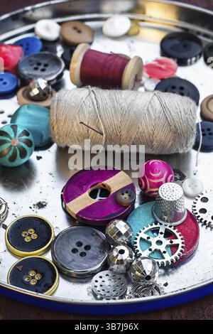 set of threads and buttons on old wooden background Stock Photo - Alamy