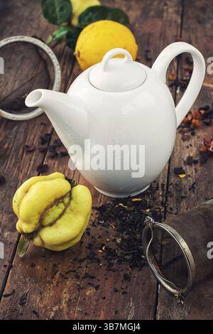 Still life with fruit tea, spices, nuts and apple standing on light ...