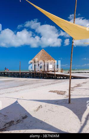 Holbox, Mexico - 9 February 2025: Long shadows from beach canopies fall ...