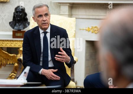 Prime Minister Mark Carney speaks to reporters as he arrives to a ...