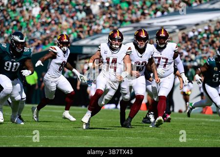 Philadelphia Eagles quarterback Sam Howell warms up after the delay due to lightning in the area ...