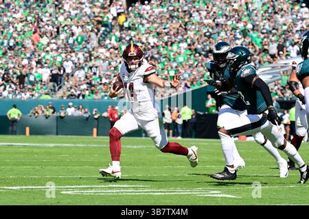 Philadelphia Eagles quarterback Sam Howell warms up after the delay due to lightning in the area ...