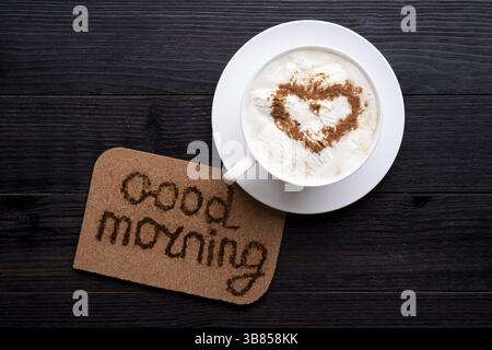 Porcelain cup of coffee with ice cream and cinnamon heart served at ...