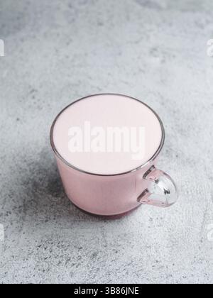 Glass of tasty rose latte on color background Stock Photo - Alamy