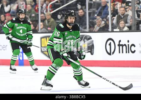 North Dakota forward Dylan James skates to the puck during their game ...