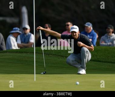 Wyndham Clark lines up a putt on the first hole during the final round ...