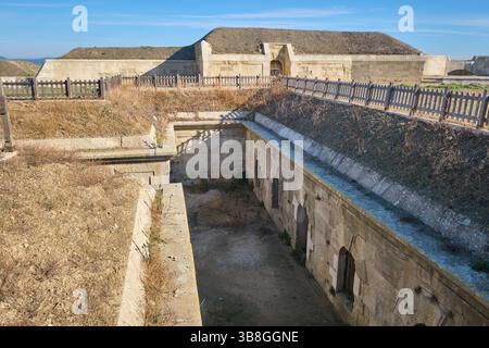 Exterior view of the berm design and fortifications of the complex. At ...